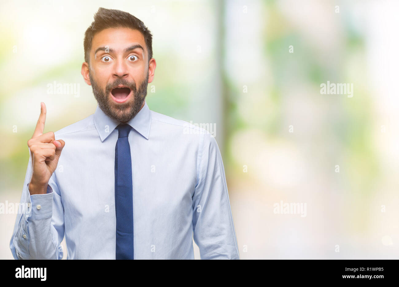 Adult hispanic business man over isolated background pointing finger up ...