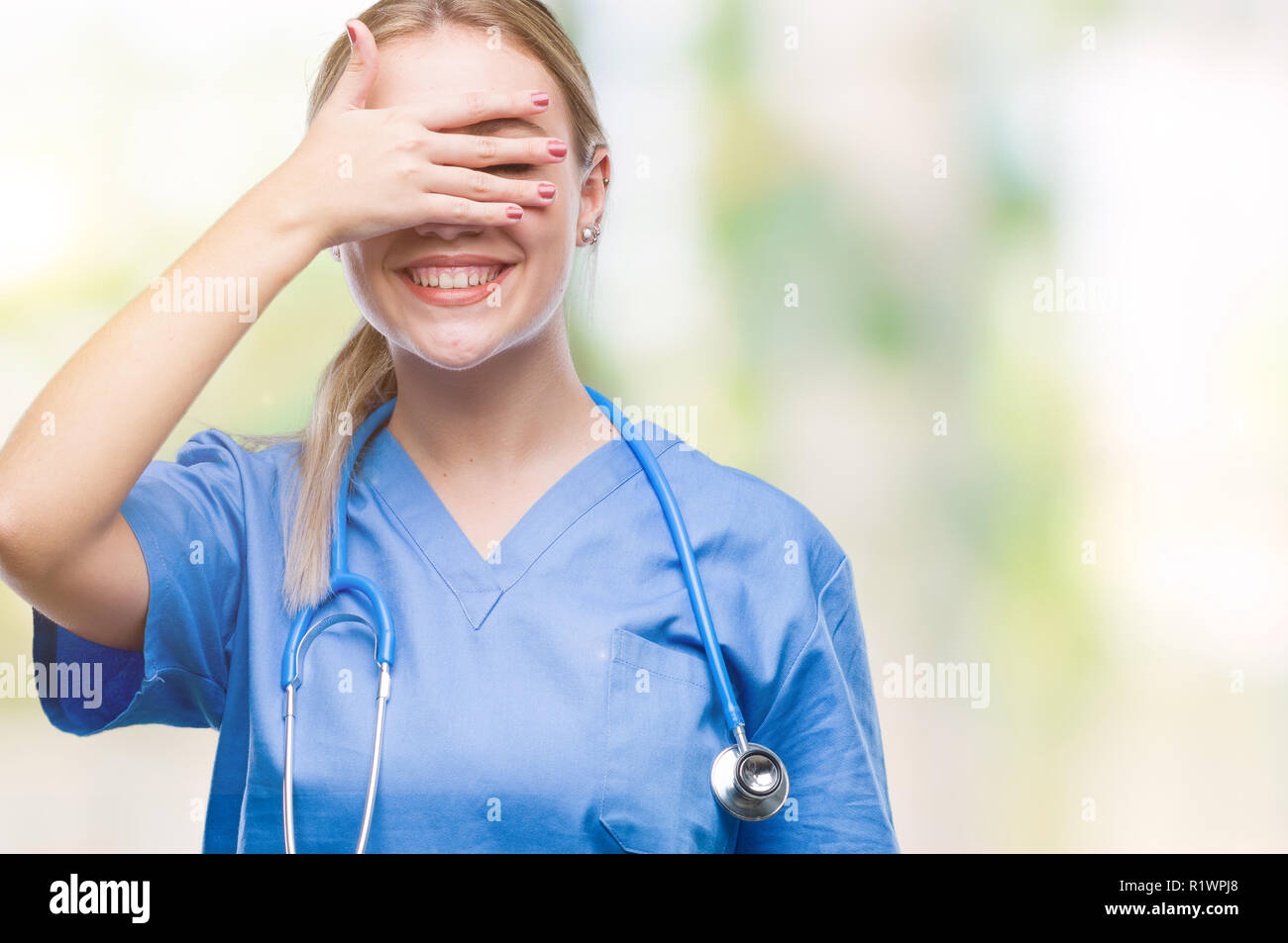 Young blonde surgeon doctor woman over isolated background smiling and ...