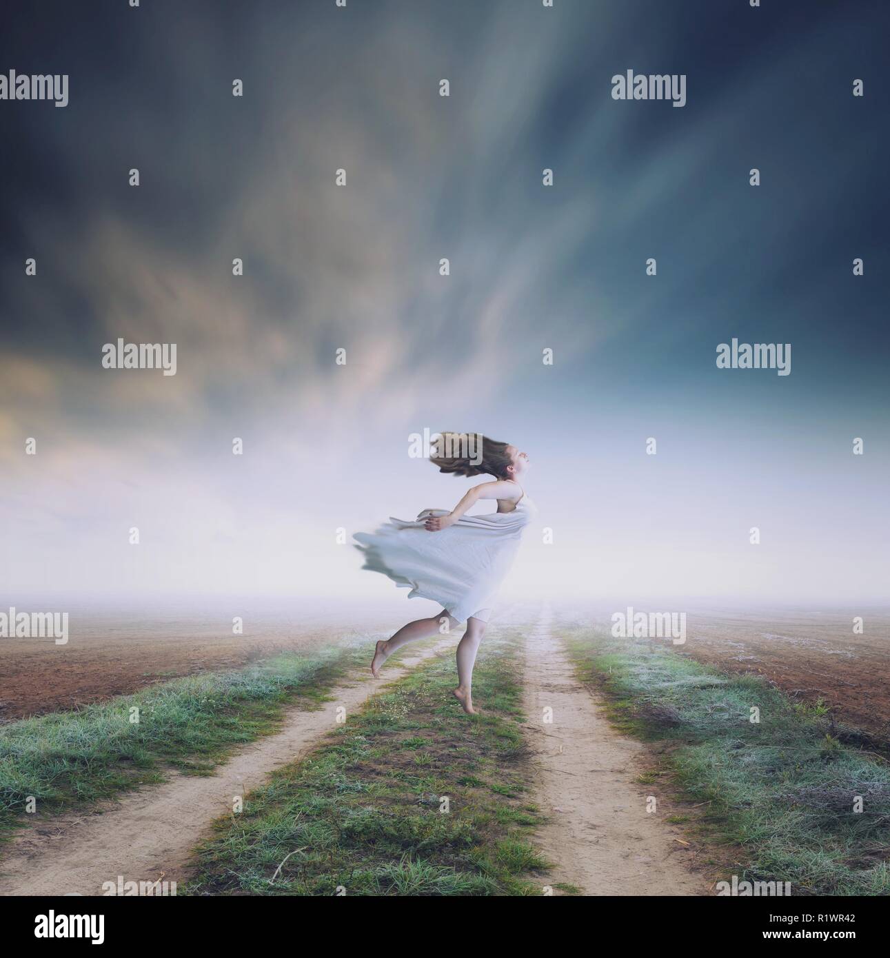 Surreal calm foggy landscape with woman dancing on wind. Surreal scene ...
