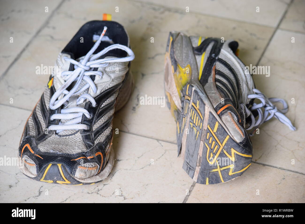 Pair of old Run and walking shoes worn out and with holes under the ...