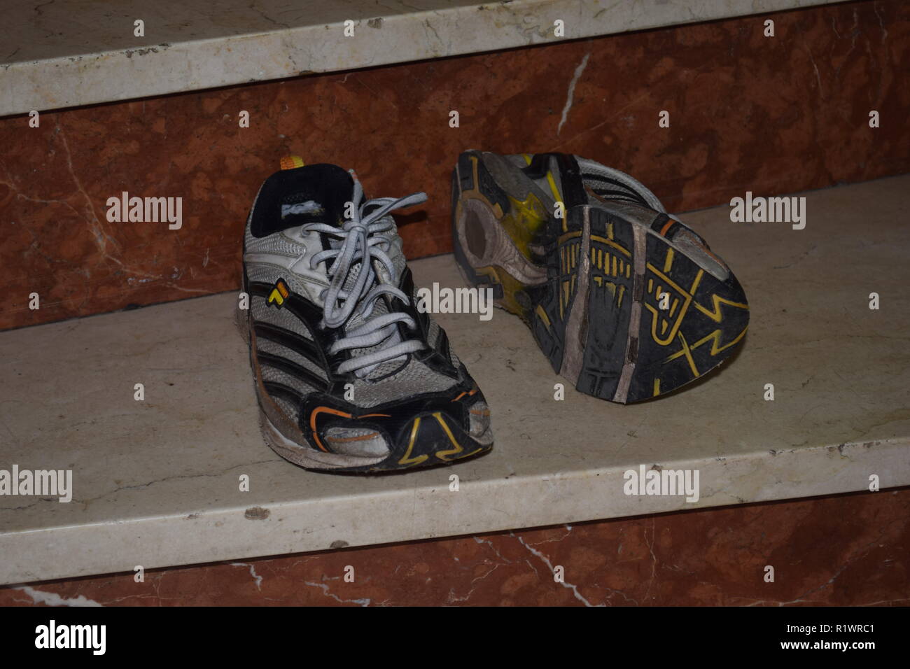 Pair of old Run and walking shoes worn out and with holes under the ...