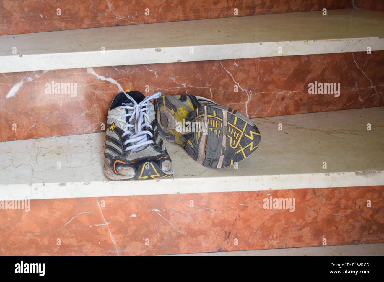 Pair of old Run and walking shoes worn out and with holes under the ...