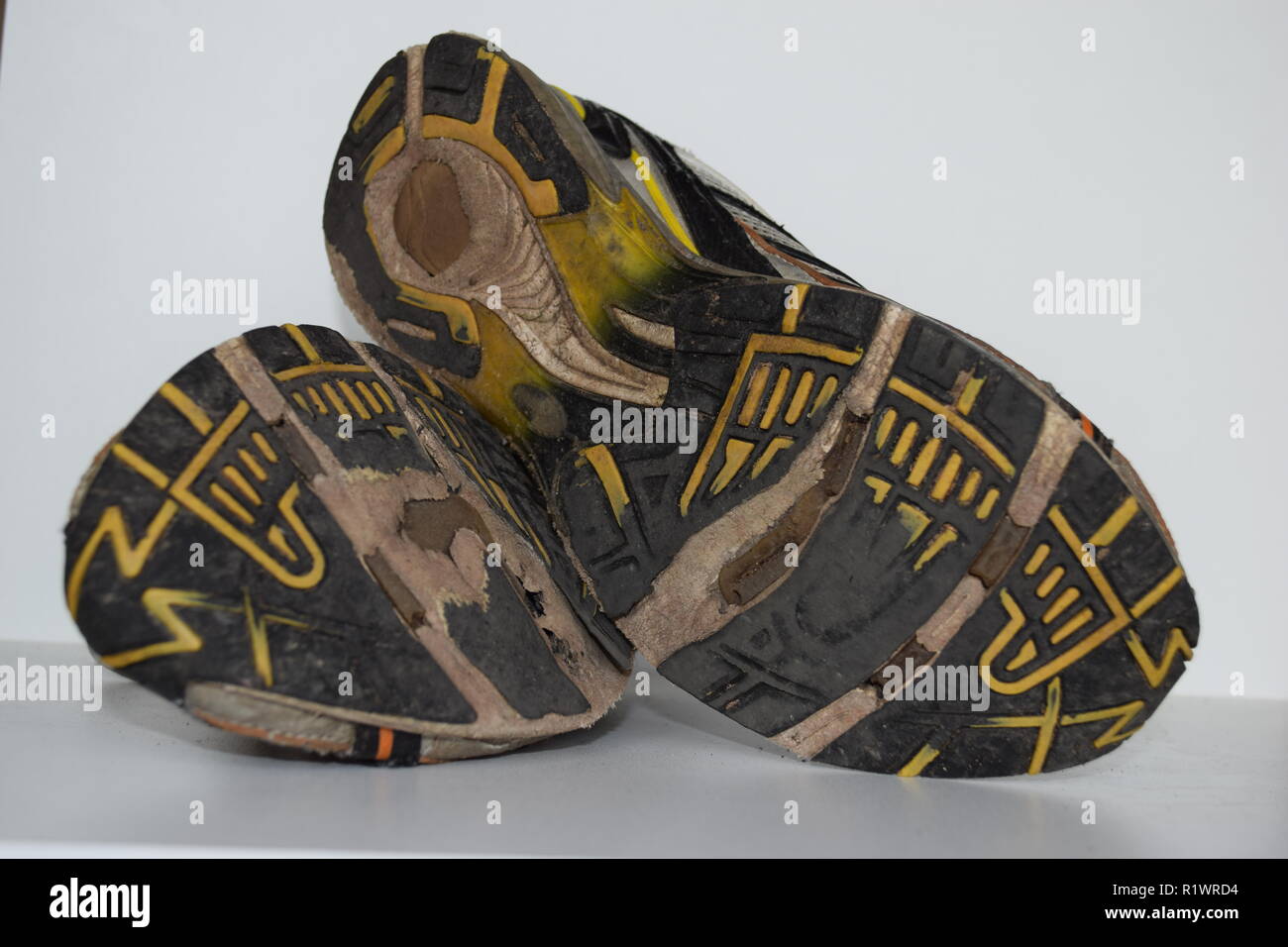 Pair of old Run and walking shoes worn out and with holes under the ...