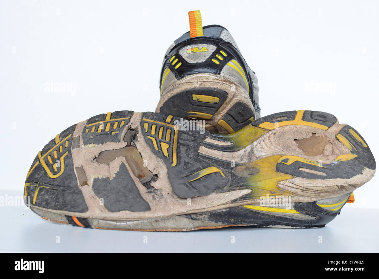 Pair of old Run and walking shoes worn out and with holes under the ...