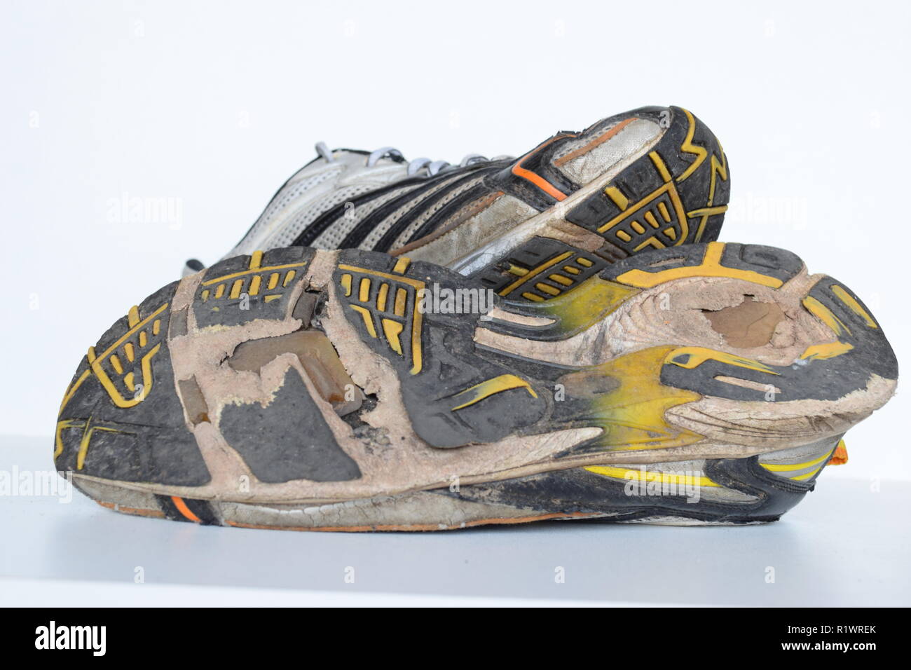 Pair of old Run and walking shoes worn out and with holes under the ...