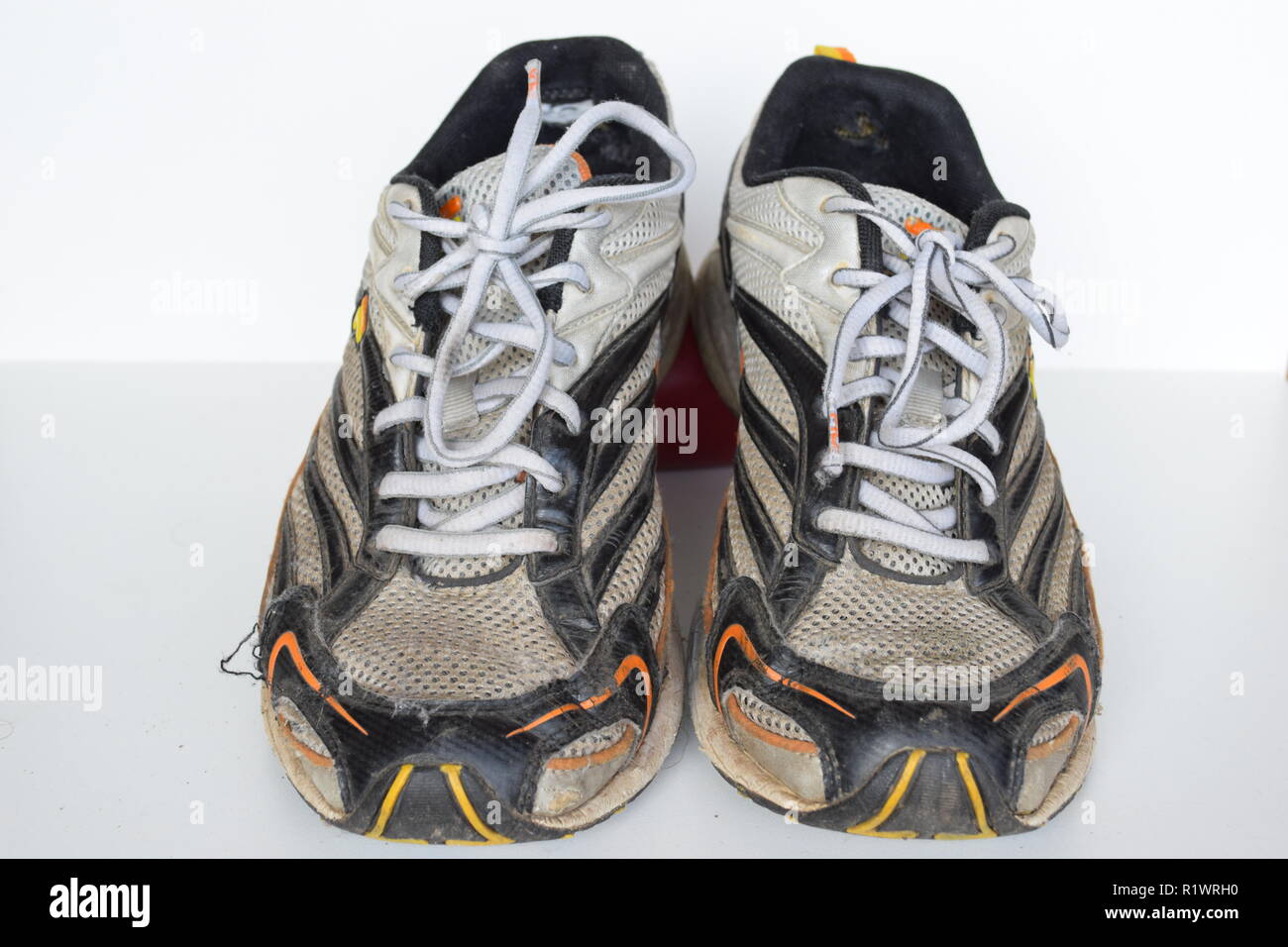 Pair of old Run and walking shoes worn out and with holes under the ...