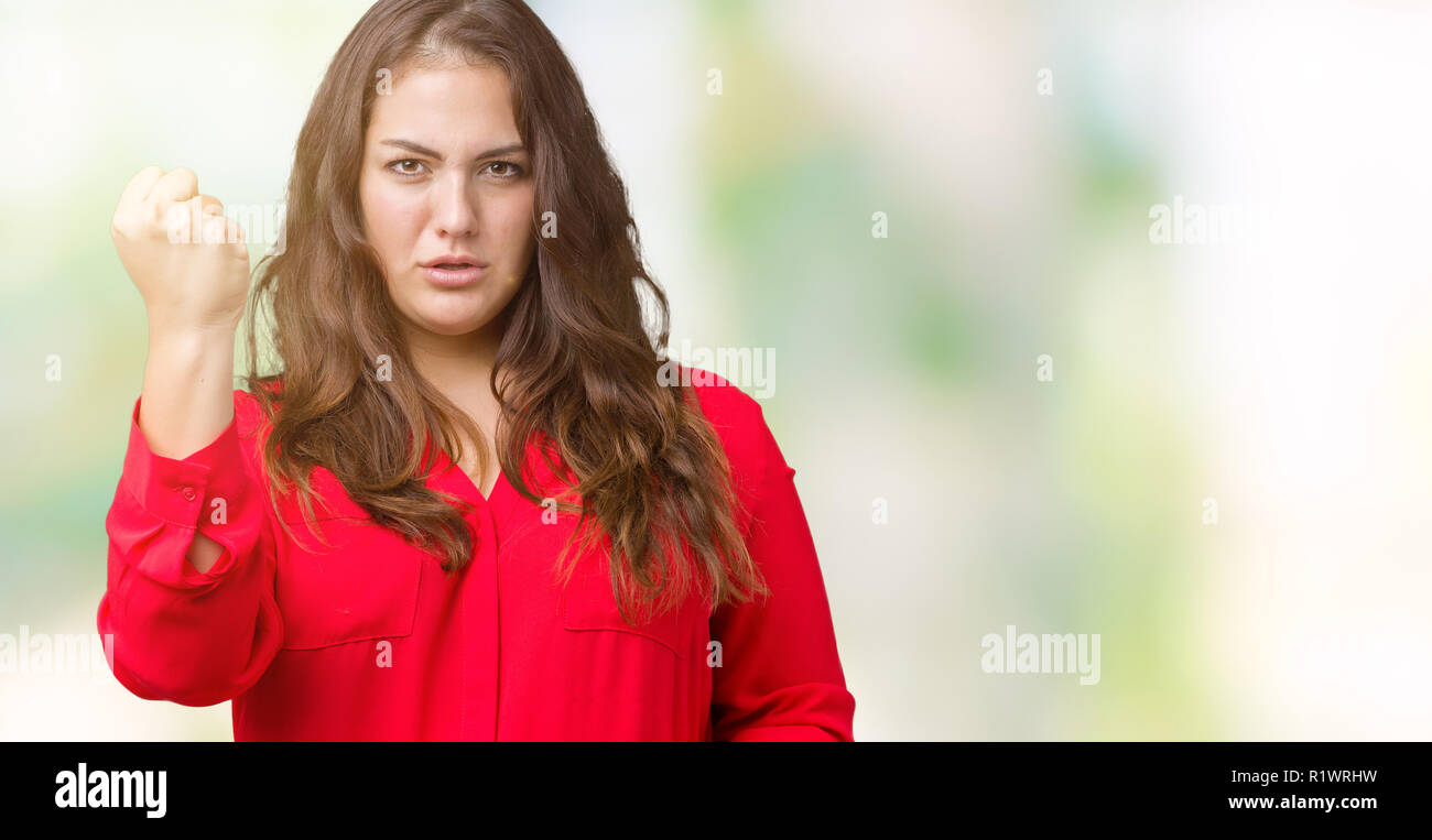 Beautiful plus size young business woman over isolated background angry ...