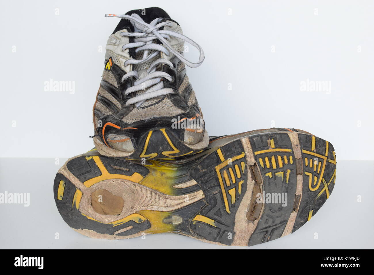 Pair of old Run and walking shoes worn out and with holes under the ...