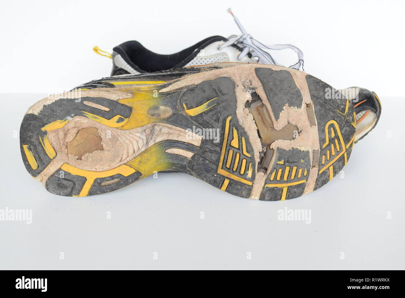 Pair of old Run and walking shoes worn out and with holes under the ...