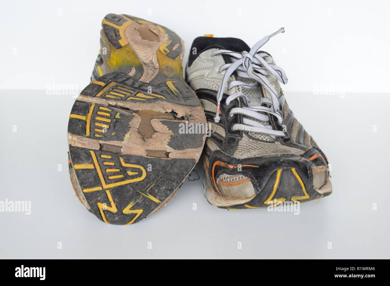 Pair of old Run and walking shoes worn out and with holes under the ...