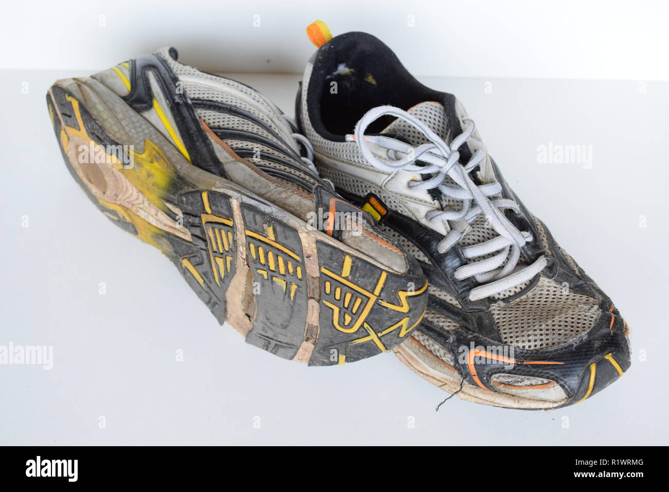 Pair of old Run and walking shoes worn out and with holes under the ...