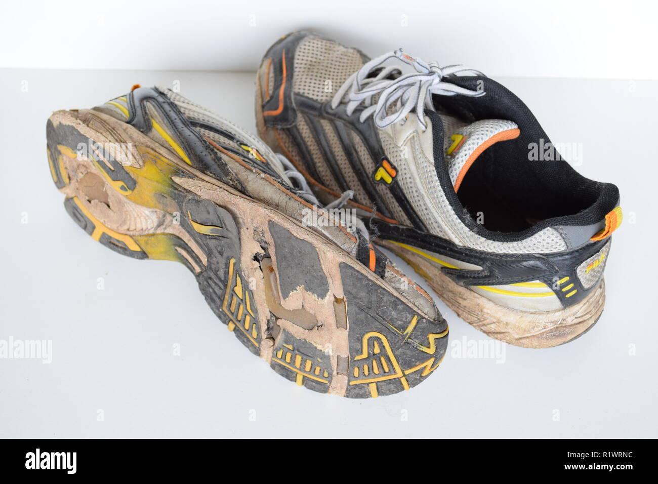 Pair of old Run and walking shoes worn out and with holes under the ...