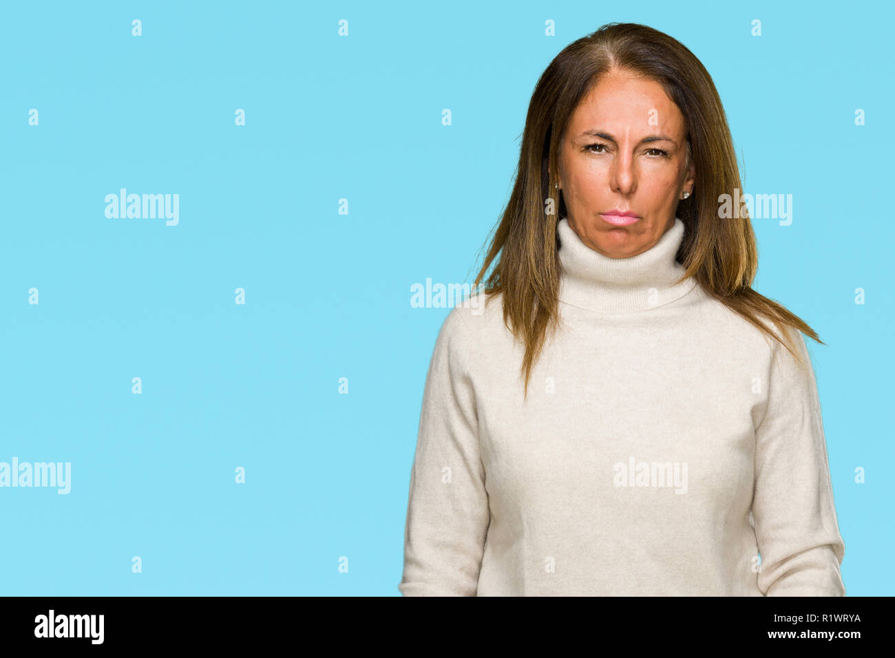 Beautiful middle age adult woman wearing winter sweater over isolated ...