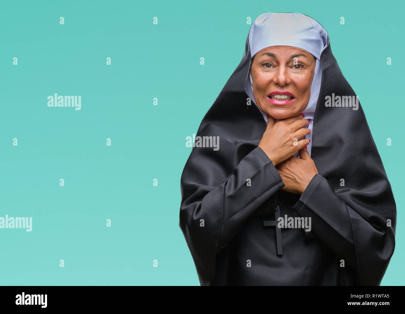 Middle age senior christian catholic nun woman over isolated background ...