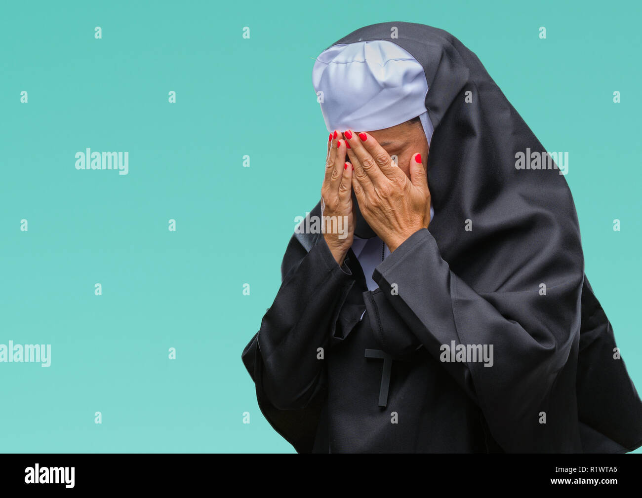 Middle age senior christian catholic nun woman over isolated background ...