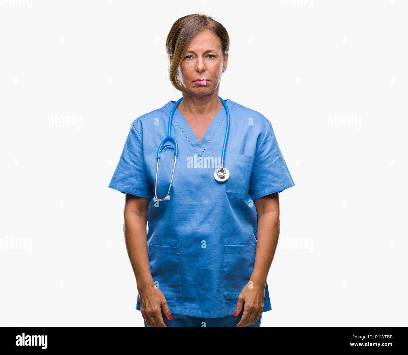 Middle age senior nurse doctor woman over isolated background depressed ...