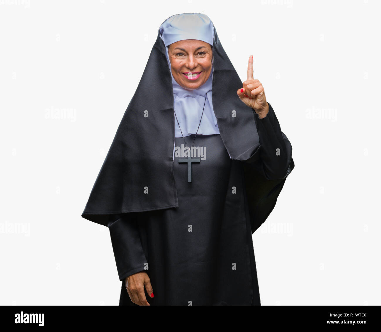 Middle age senior christian catholic nun woman over isolated background ...