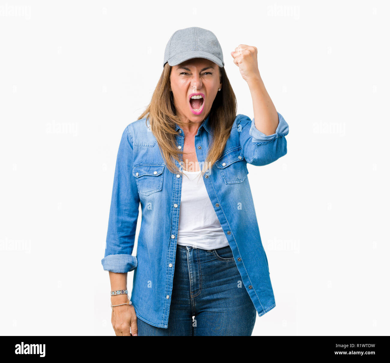 Beautiful middle age woman wearing sport cap over isolated background ...