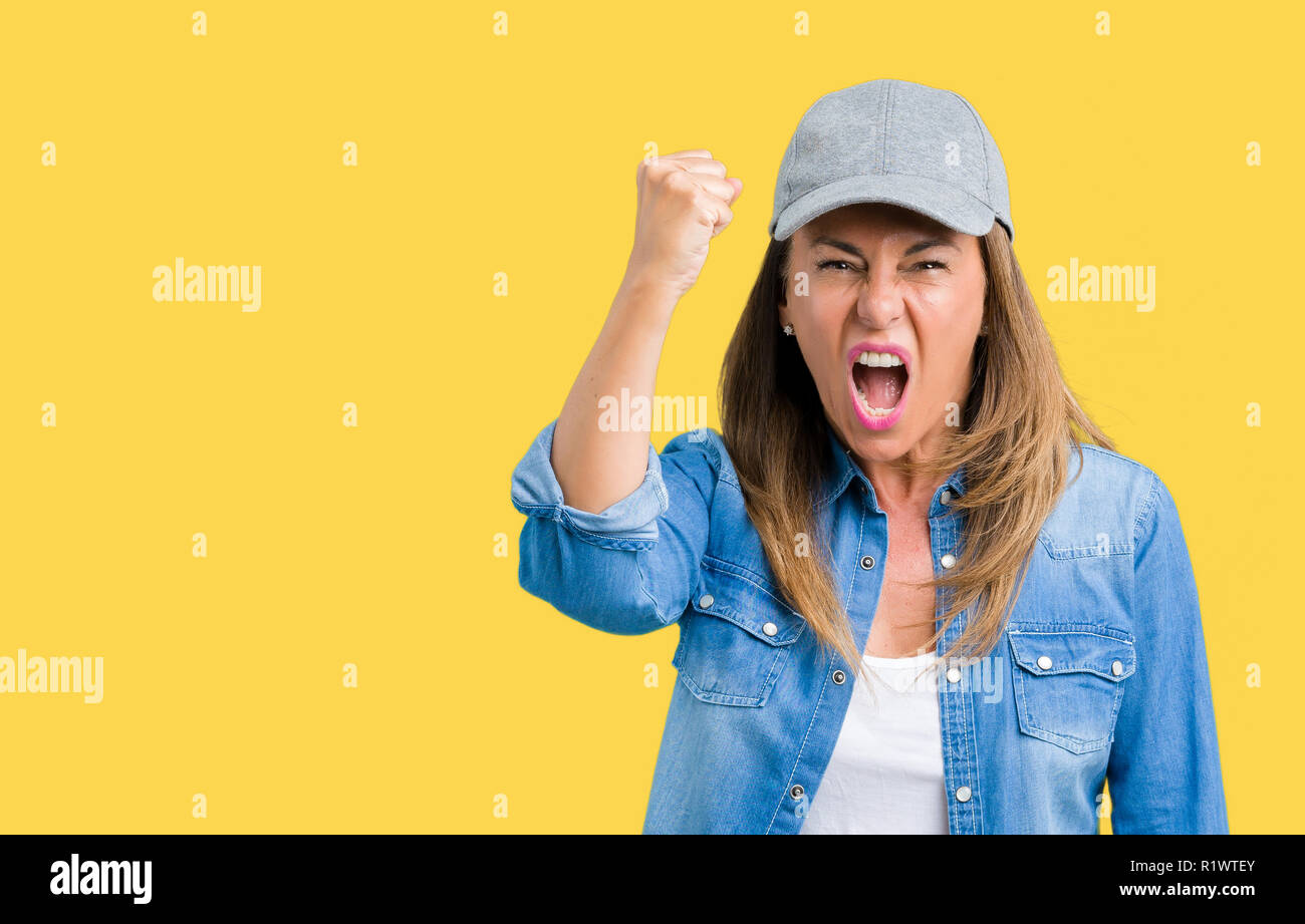 Beautiful middle age woman wearing sport cap over isolated background ...