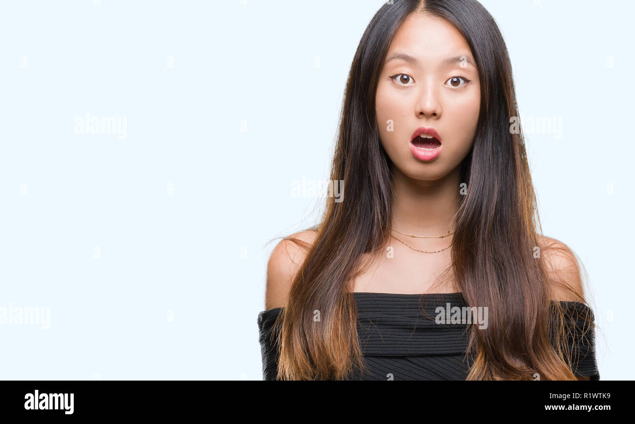 Young asian woman over isolated background afraid and shocked with ...