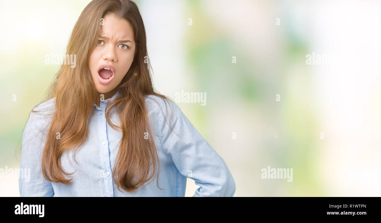 Young beautiful brunette business woman over isolated background In ...