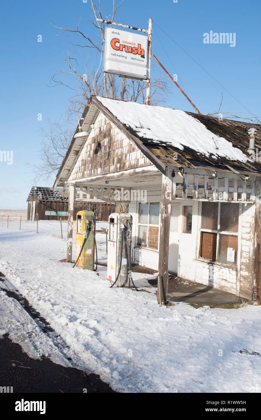 Closed gas station in rural west with weathered wood white building and ...
