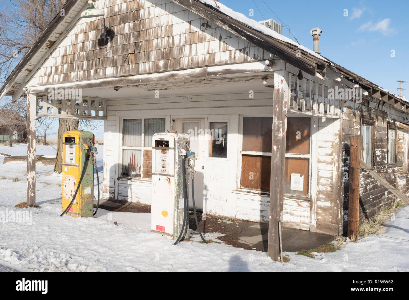 Closed gas station in rural west with weathered wood white building and ...