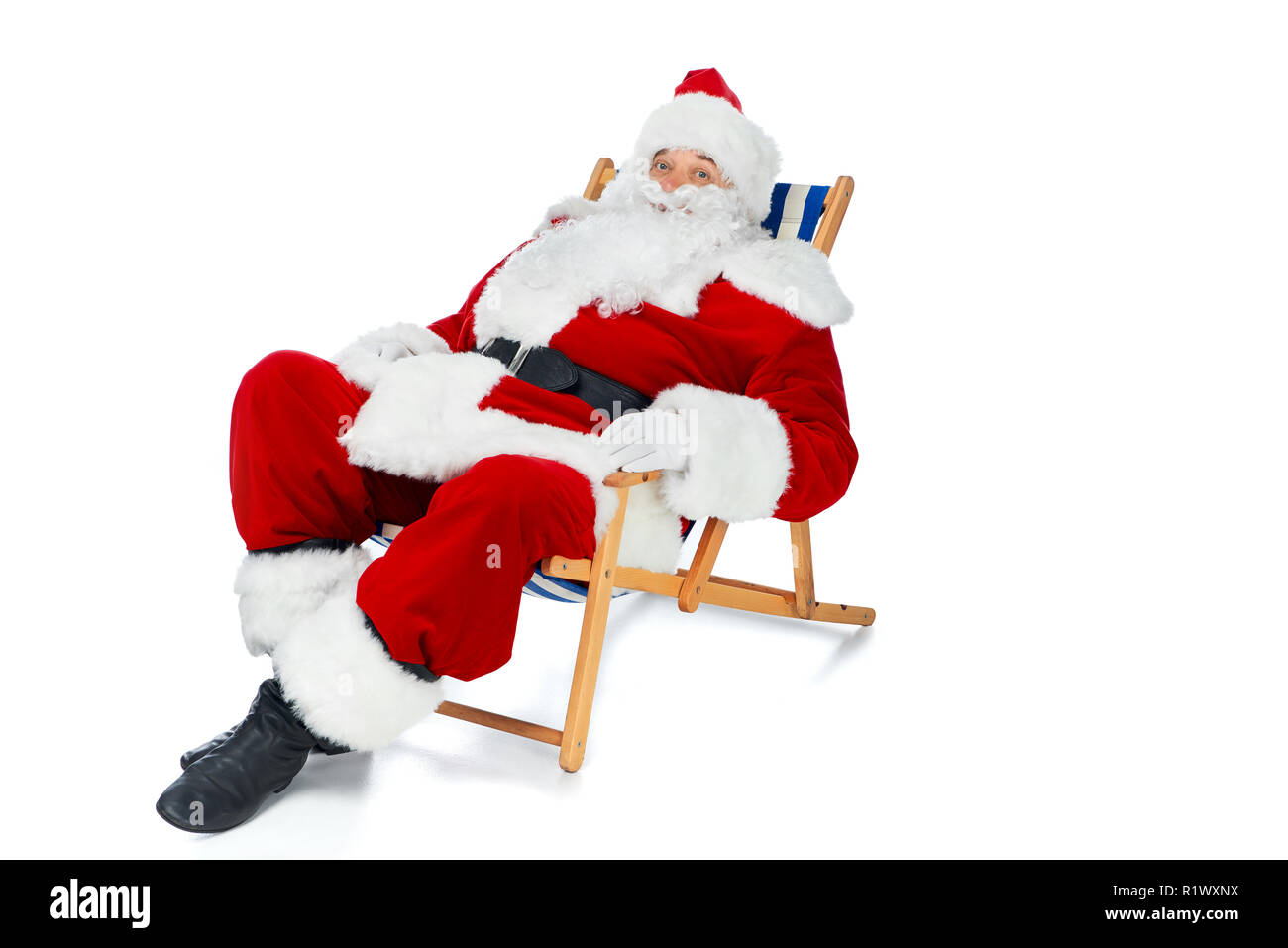 happy santa claus resting on beach chair on white Stock Photo - Alamy