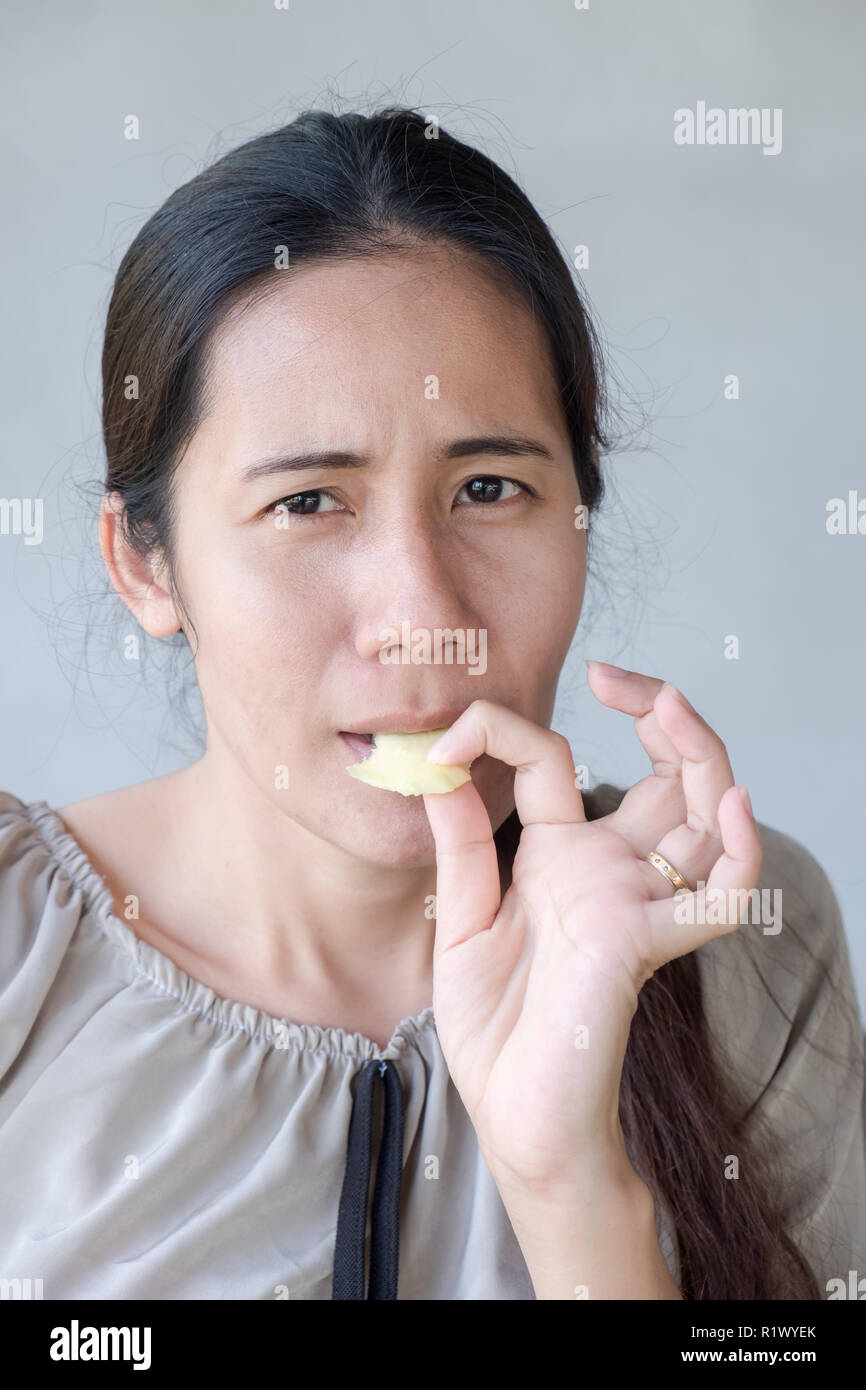 Emotions from the sour on the cute asian woman face Stock Photo - Alamy