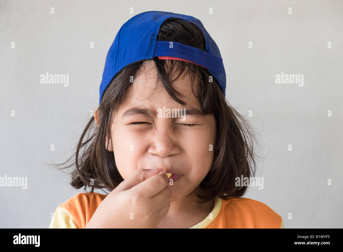 Emotions from the sour on the girl's face Stock Photo - Alamy