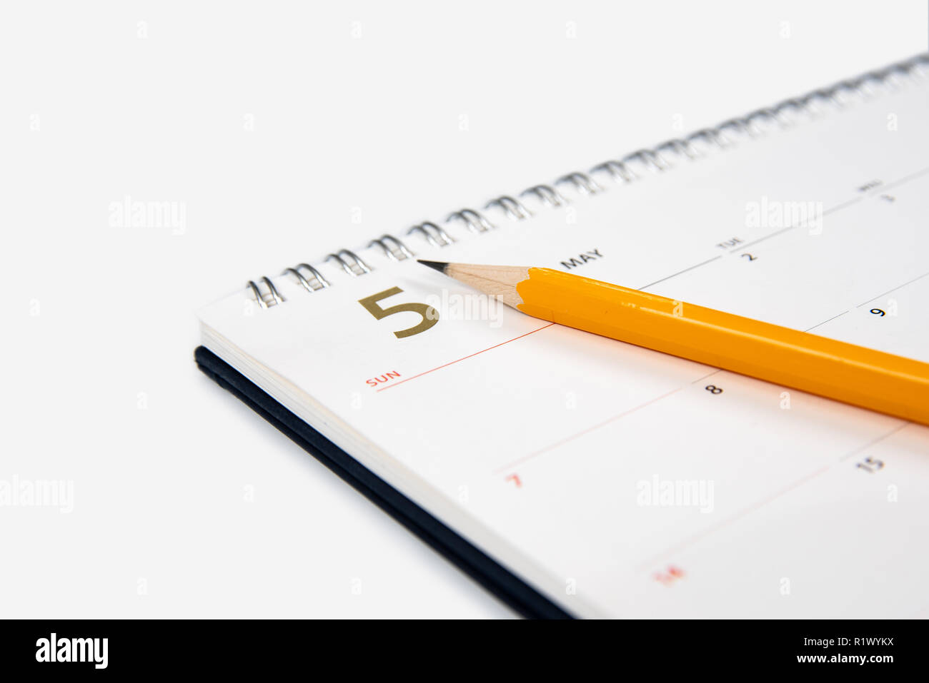 May calendar and pencil on white background Stock Photo - Alamy