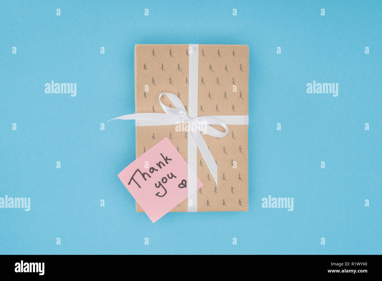 top view of gift box with sticky note with thank you lettering isolated ...