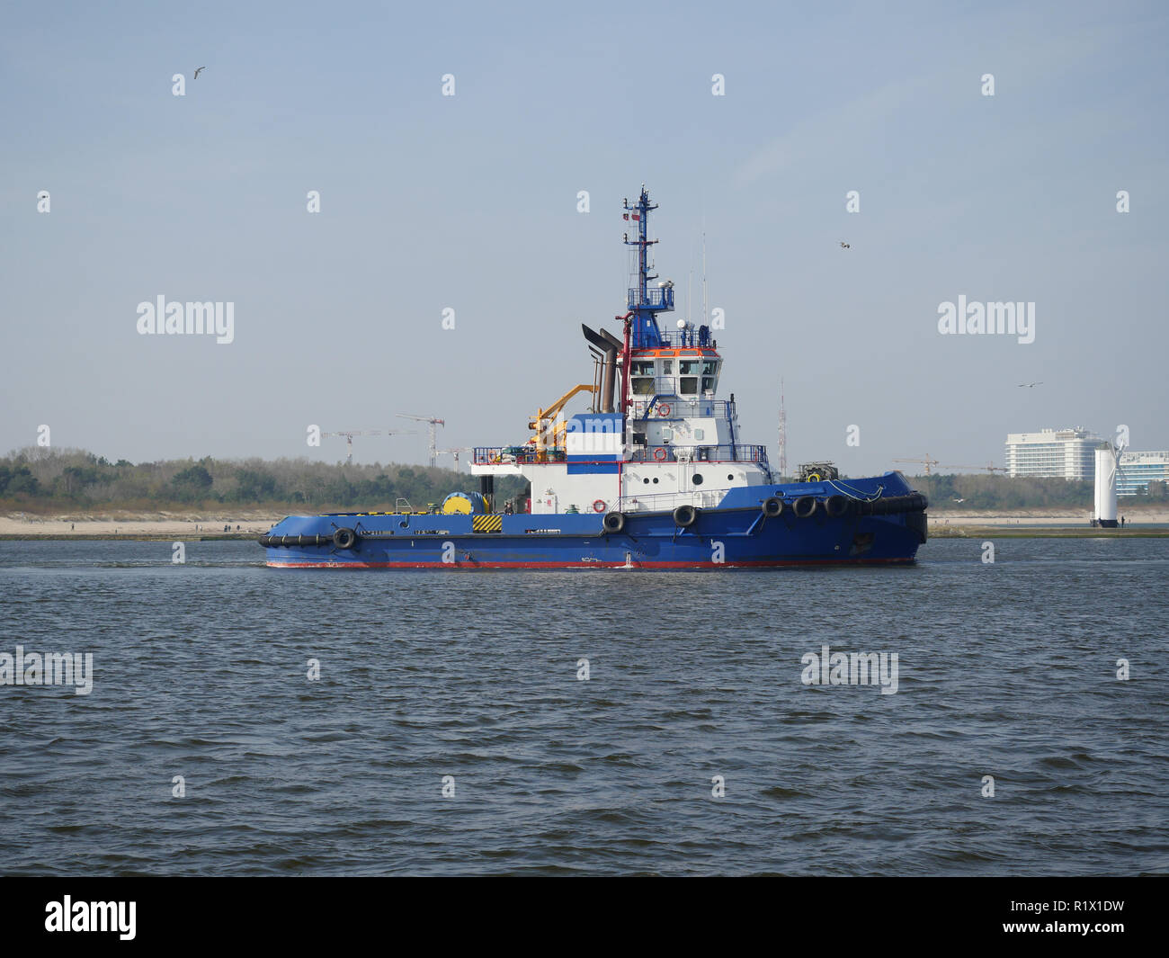 blue tug ship on sky background Stock Photo - Alamy