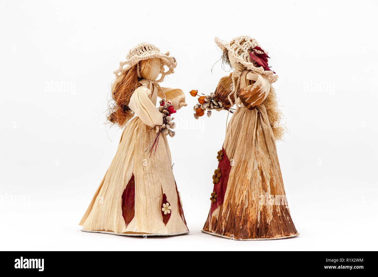 Corn husk doll hands with flowers isolated on white background ...