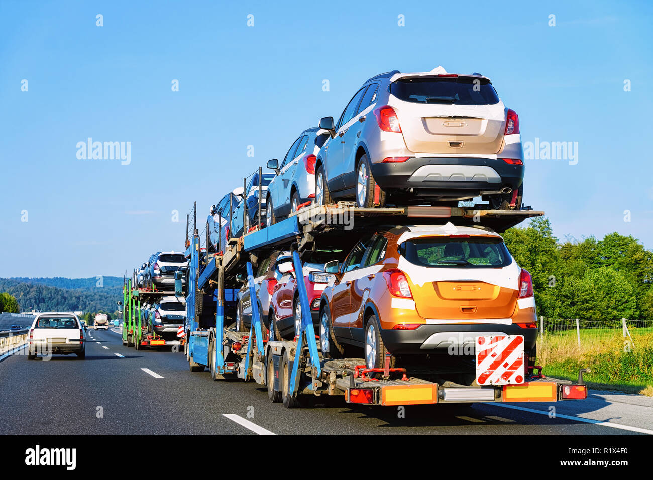 Cars carrier truck at the asphalt highway in Poland. Truck transporter ...