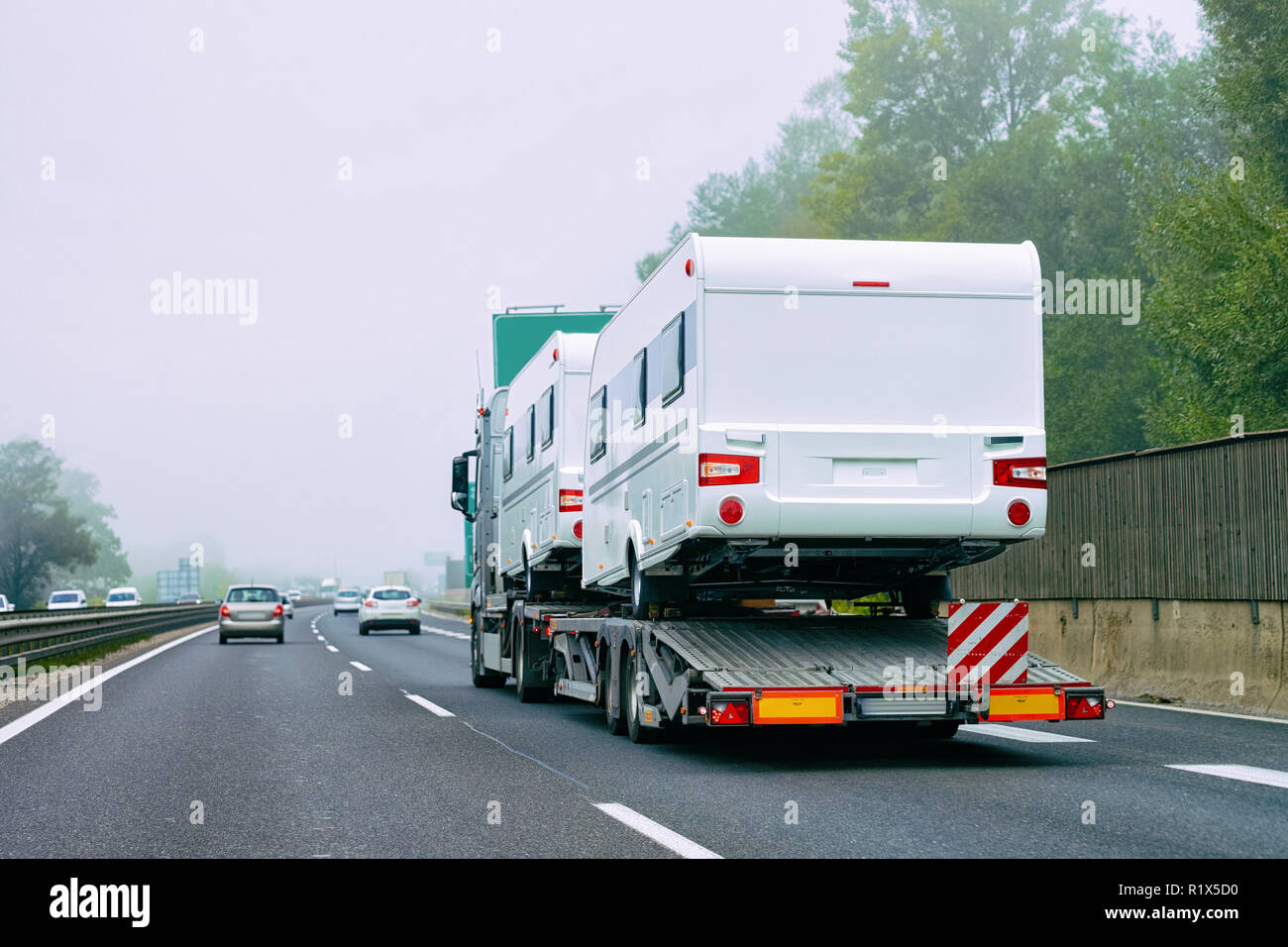 Truck carrier with motor homes rv on the asphalt road of Slovenia Stock ...