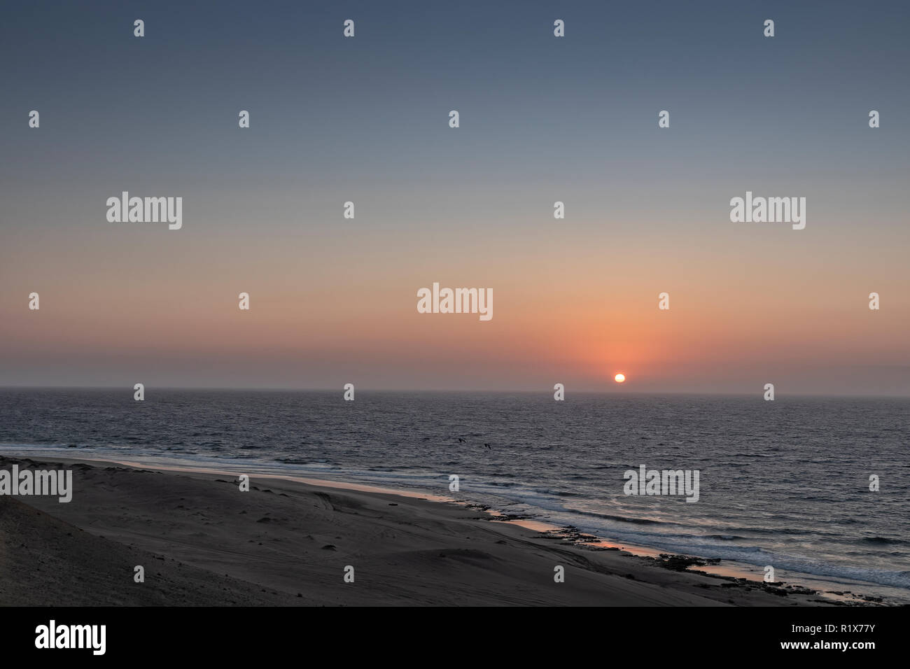 Beautiful sunset on the wild Namibe beach with canyons and desert Stock ...