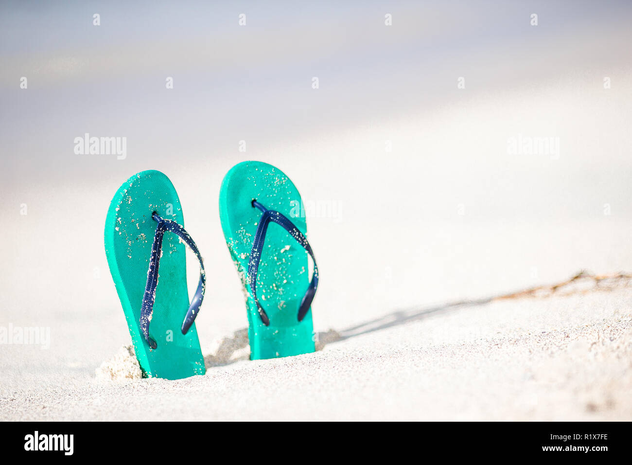 Summer mint flip flops with sunglasses on white beach Stock Photo - Alamy
