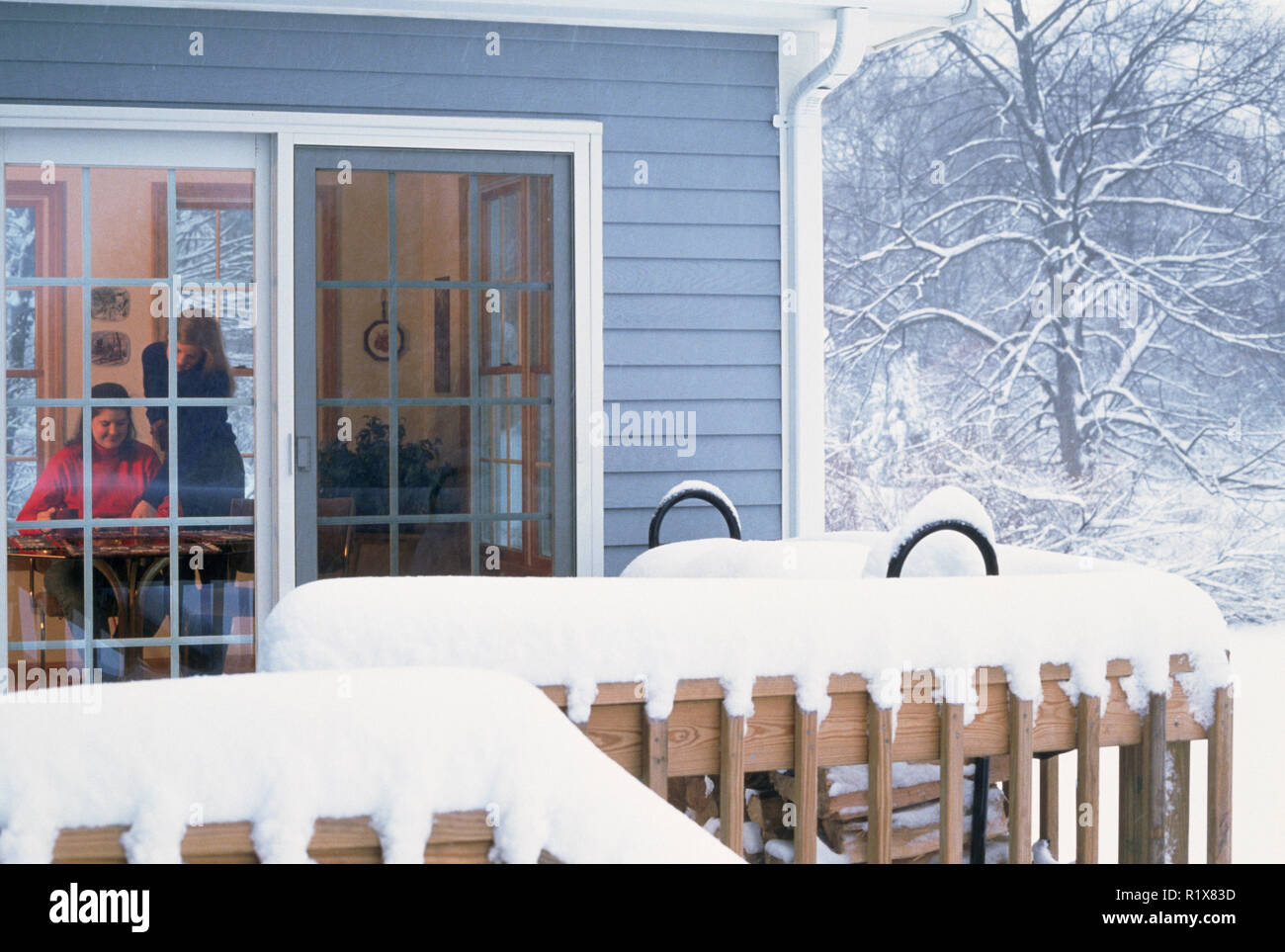 Two young Women inside a Cozy House in a Snowstorm, Northeastern USA ...