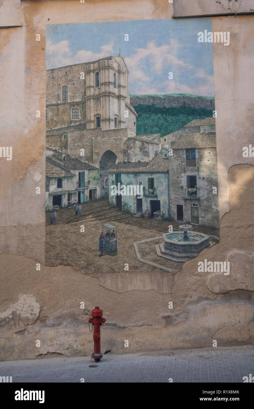 Mural depicting elements of city history with a red fire hydrant below ...