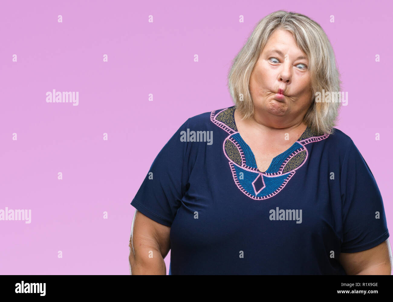 Senior plus size caucasian woman over isolated background making fish ...