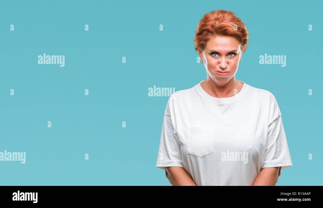 Atrractive senior caucasian redhead woman over isolated background ...