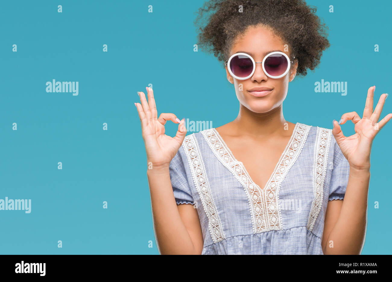 Young afro american woman wearing glasses over isolated background ...
