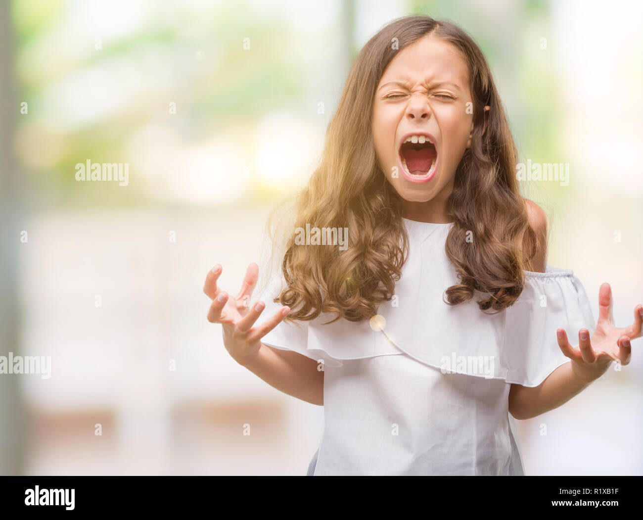 Brunette hispanic girl crazy and mad shouting and yelling with ...