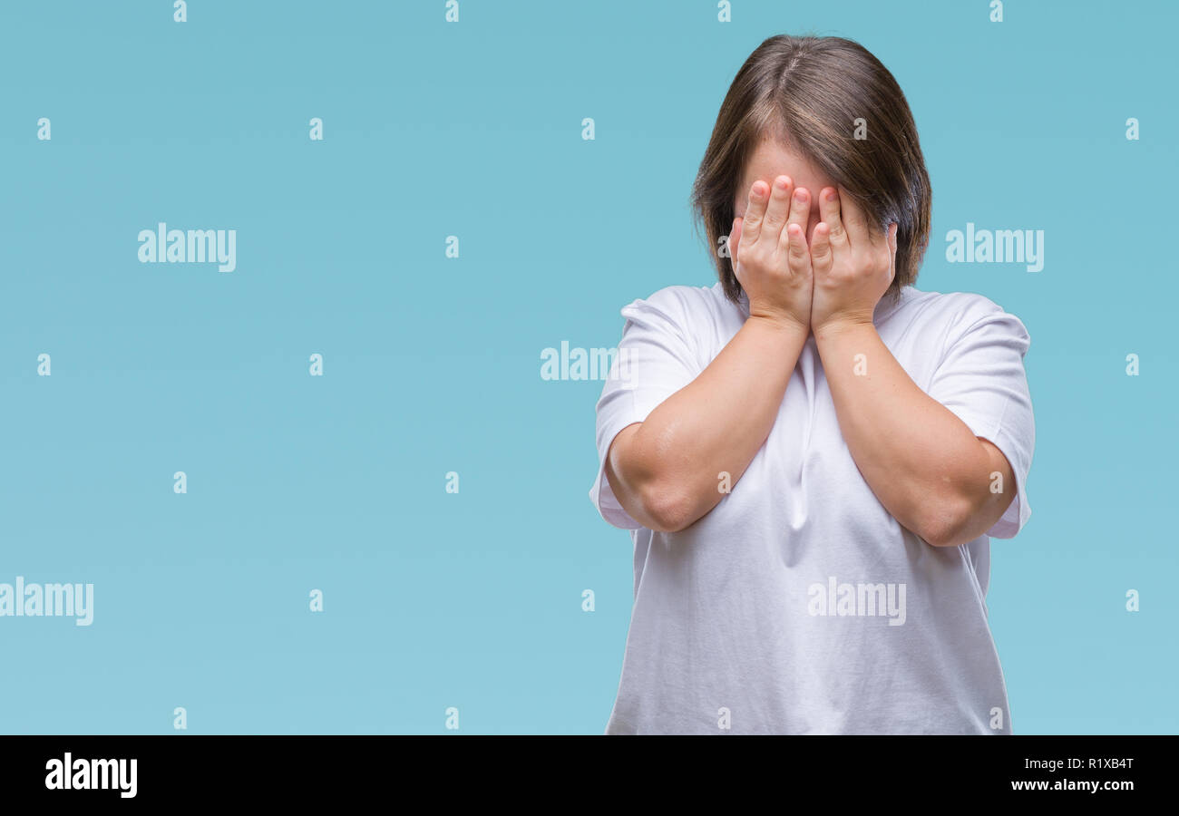 Young adult woman with down syndrome over isolated background with sad ...