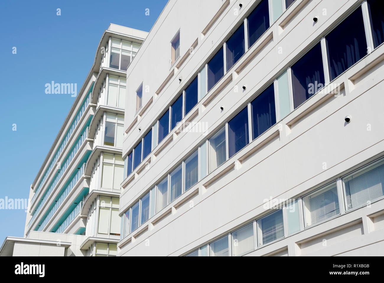 Hospital building with sky reflecting in the glass Stock Photo - Alamy
