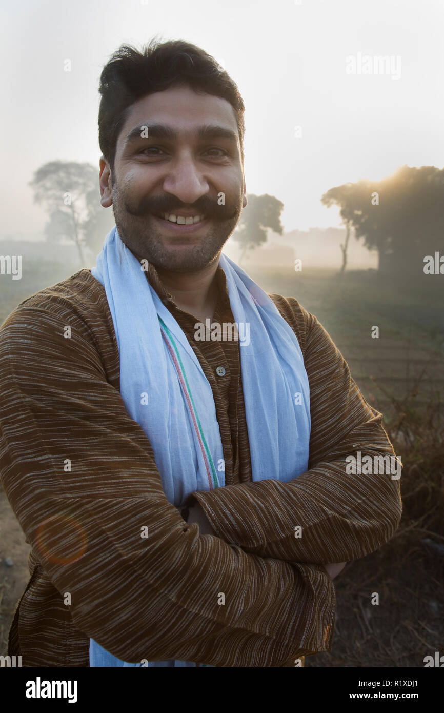 Portrait of a smiling village man or farmer standing in agriculture ...