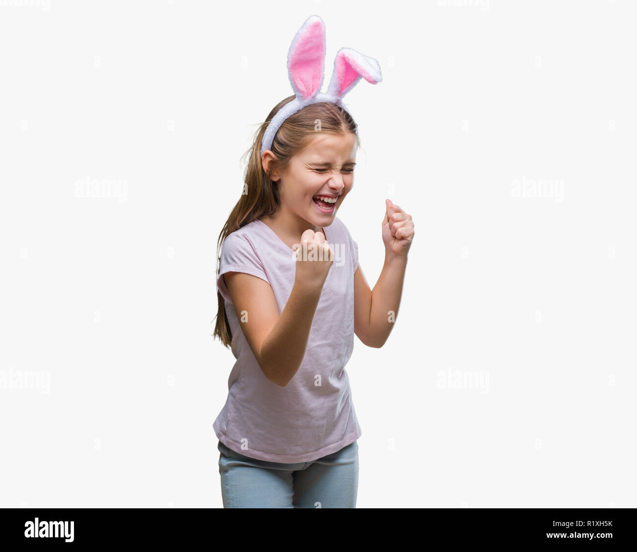 Young beautiful girl wearing easter bunny ears over isolated background ...