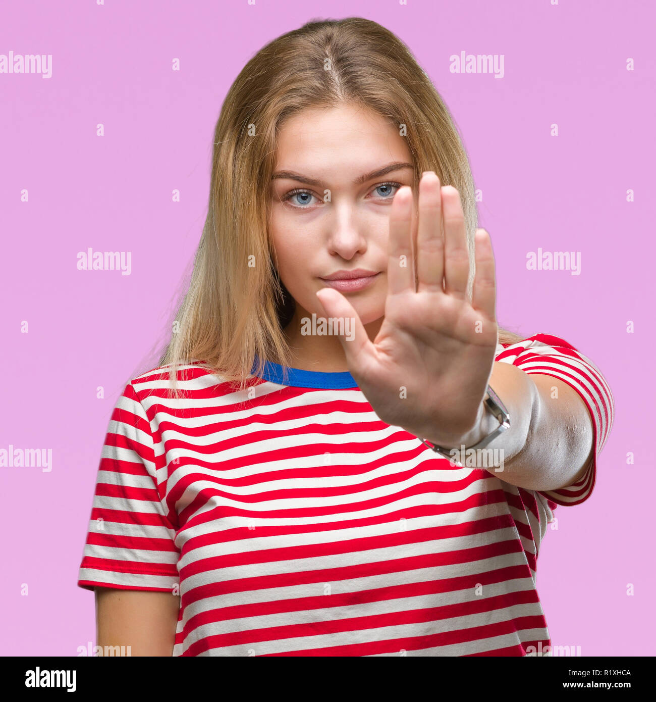 Young caucasian woman over isolated background doing stop sing with ...