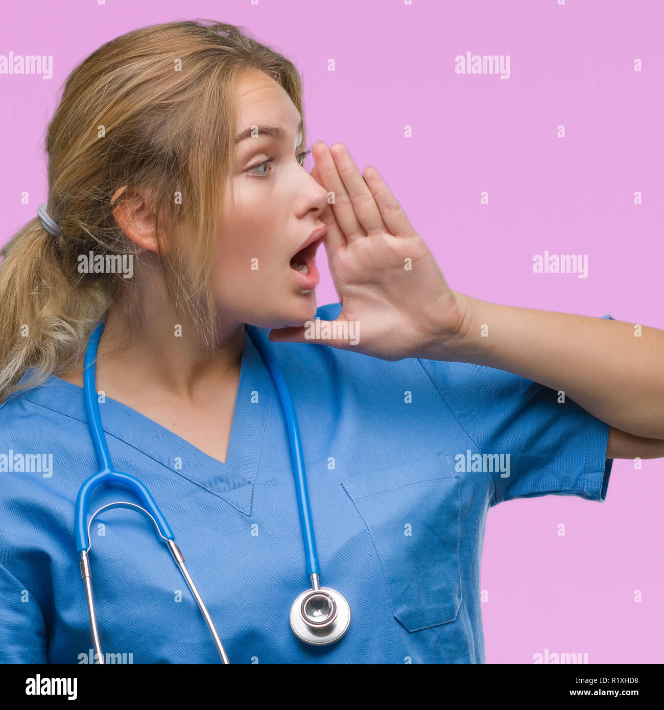 Young caucasian doctor woman wearing surgeon uniform over isolated ...